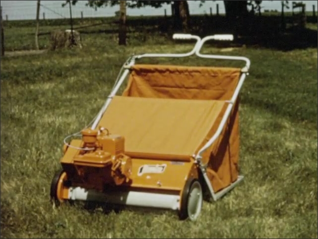 1960s: Two lawn-sweepers, one model is self-propelled. Man pushes lawn ...