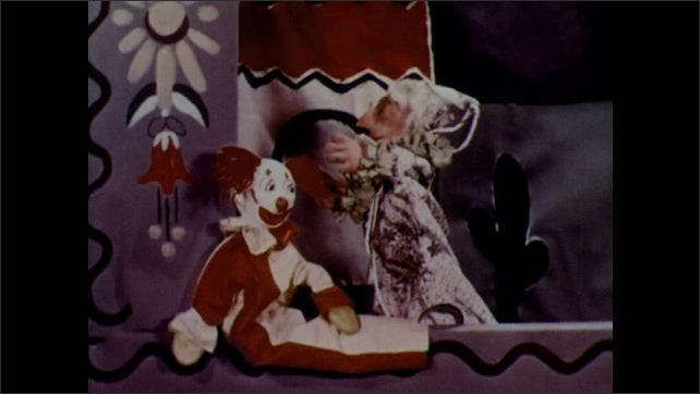 1950s: Stage curtain opens and puppets move. Puppet gestures. Clown ...