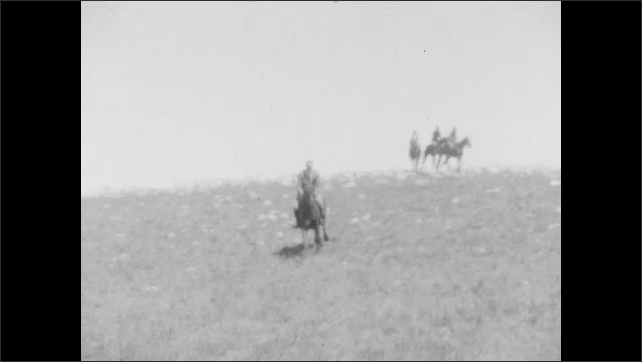 1920s: soldiers riding horses at top of hill and then down the slope ...