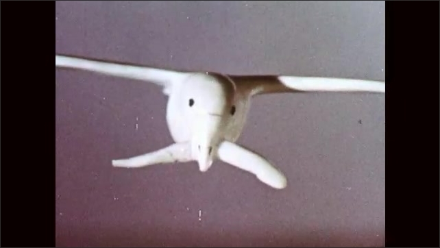 1950s: Statue of seagull with fish in mouth, flying in sky. Statue of ...