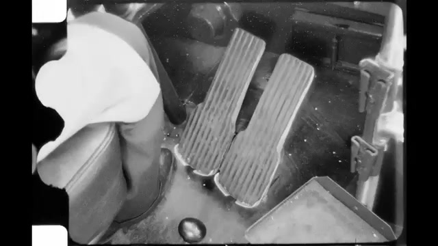 1950s: Hand points to foot pedals on trolley. Foot presses on ...