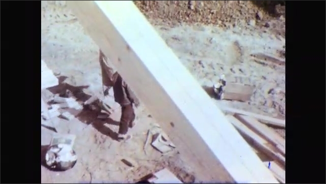 1960s: Bucket with cement goes up, construction worker takes bucket ...