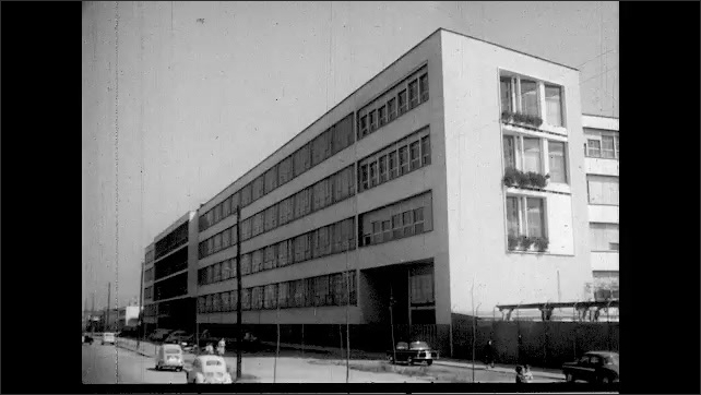 1960s: factory stacks billowing smoke in cities, cars crowding street ...