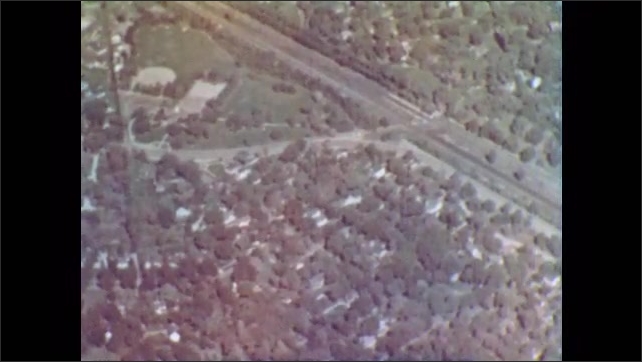 1950s: Aerial view of road and trees. – Archival Footage