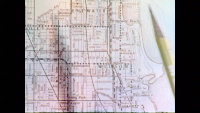 1950s: Close-up of paper map. Mother points pencil at park on map ...