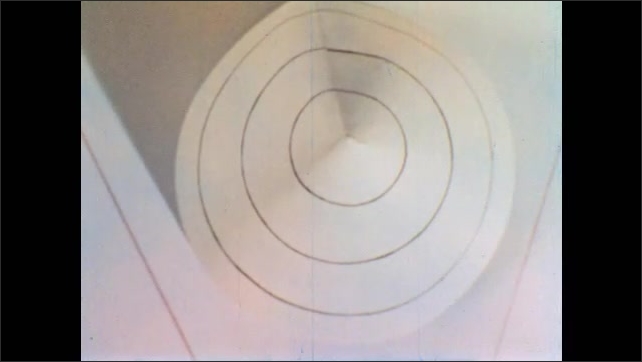 1950s: Aerial view of paper cone hill marked with regular contours ...