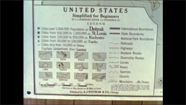 1950s: Man points to map of United States. Man points to legend of wall ...