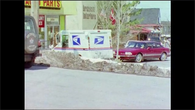 1990s: Mail truck sits in parking lot. Mail truck drives around parking ...