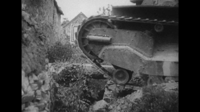 1940s: Close up, tread of tank / Tank enters village gate / Long shots ...
