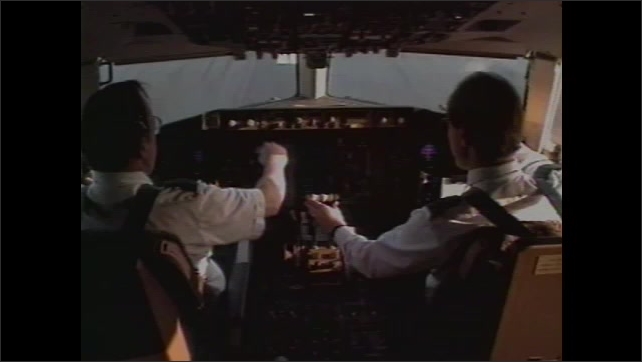 1990s: Interior of cockpit, pilots flying plane. Plane taking off ...
