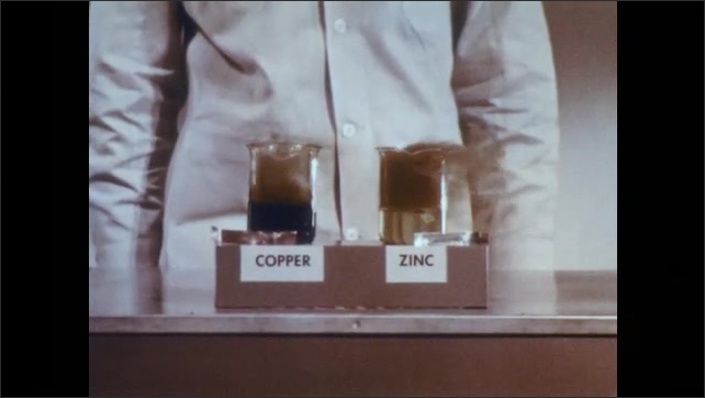 1960s: Lab. Smoke pours from beakers labelled “ZINC” and “COPPER ...