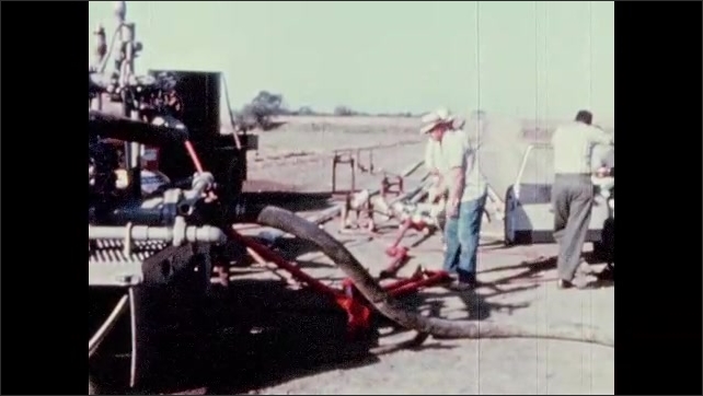 1950s: UNITED STATES: hands weld metal together. End of metal pipe ...