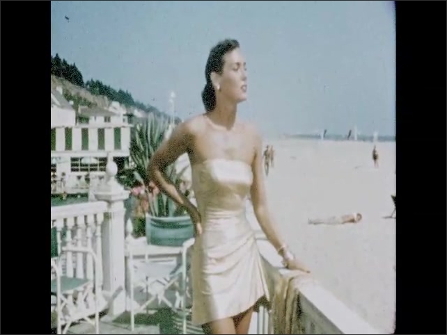 CALIFORNIA 1950s: lady poses by beach. Lady takes off beach robe ...