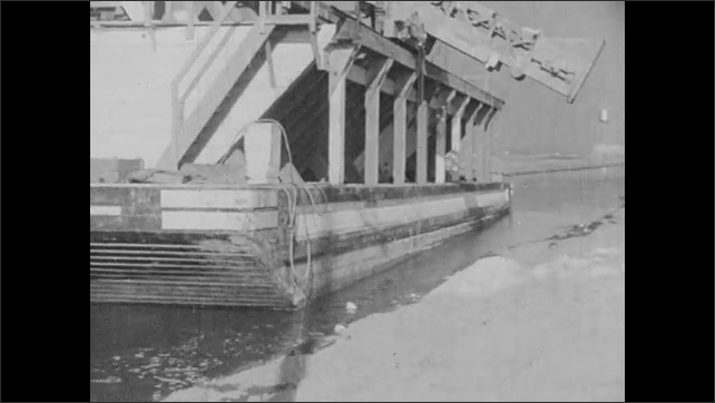 1920s: A barge is towed down a river. – Archival Footage