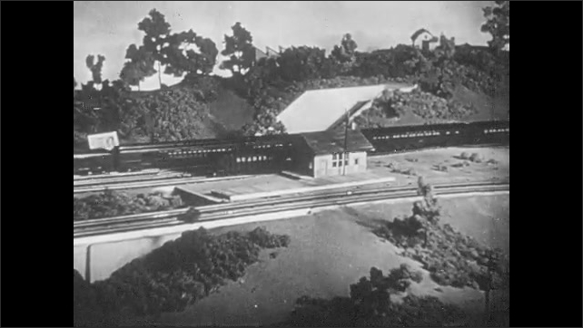 1950s: Model trains run on track through layouts. Smoke wisps out of ...