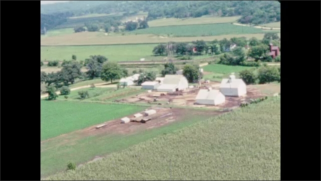 1960s: Combine in hay field. Aerial views of farms and farmlands ...