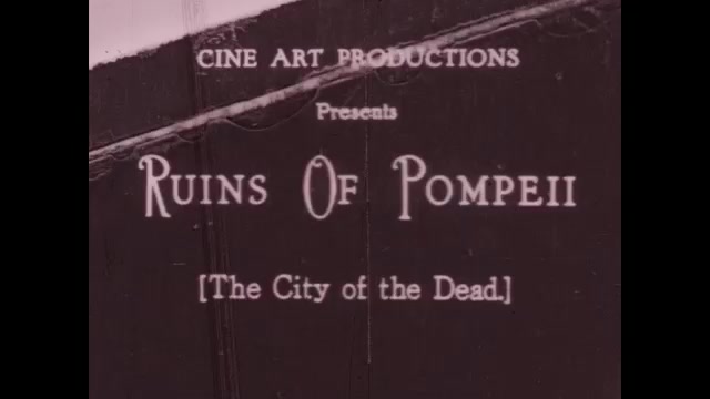 1920s: Text describing history of Pompeii. Ruined columns around road. – Archival Footage