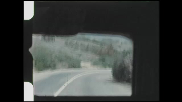 1950s: Driving down road in car. – Archival Footage