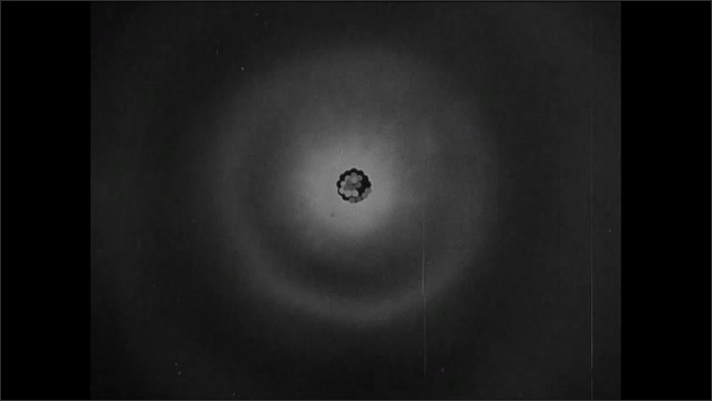 1940s: Flags appear on globe. Atomic formula and symbols appear over ...