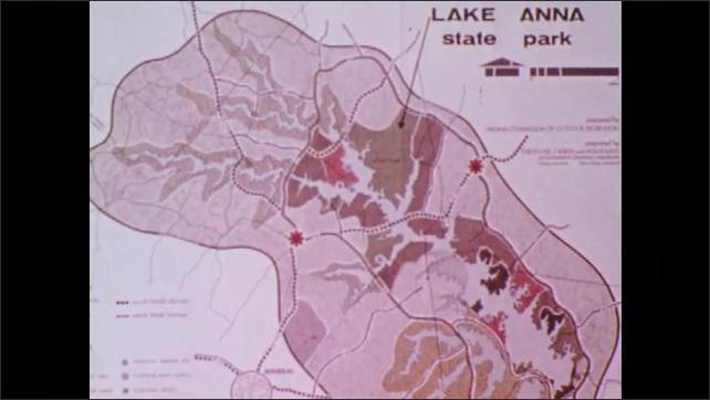 1970s: Woman uses ruler and pencil to draw lines on map. Mapped area of ...