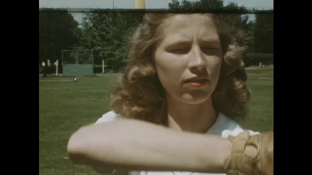 1950s: Girl practices pulling back bow and arrow slowly three times ...