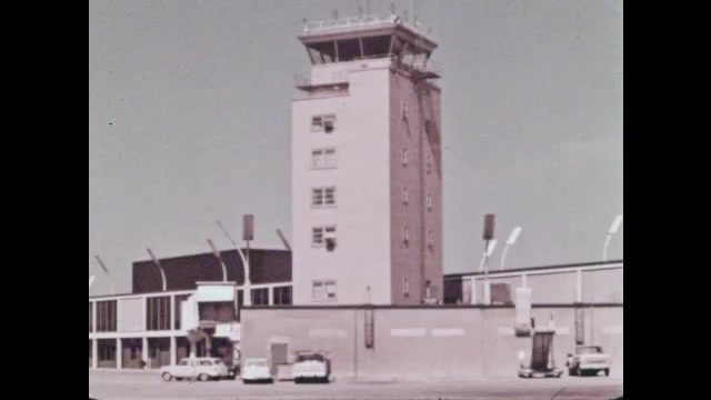 1960s: Shots of traffic control tower. Man in flight tower talking into ...
