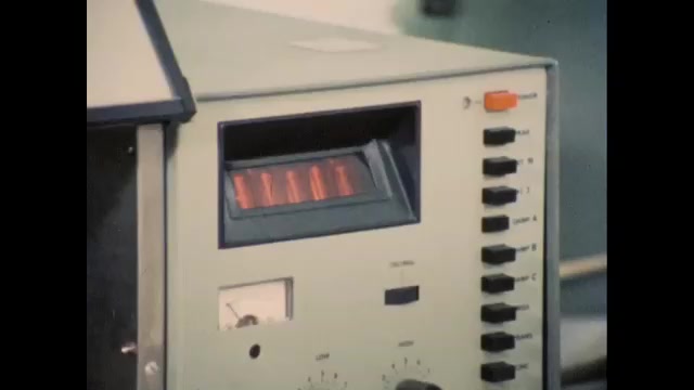 1980s: Hand pushes buttons and turns knobs on spectrograph control ...