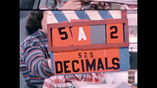 1950s: Film slate. Boy flipping through and explaining his notes. Boy ...