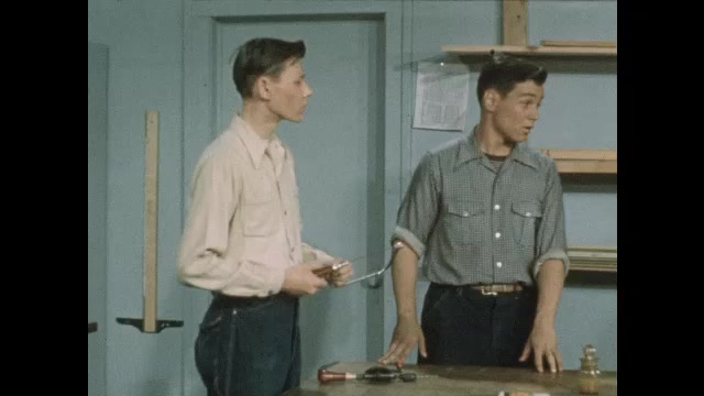 1950s: In art classroom, boy unpacks several items from box. Other teen ...