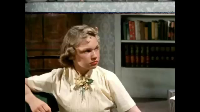 1950s: Confused looking girl talking. Boy listening and thinking ...