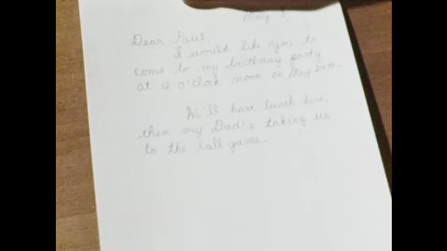1960s: Home, boy sits at desk, points to parts of handwritten letter ...