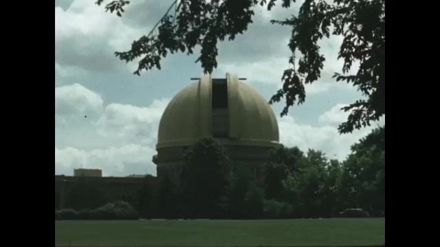 1950s: Exterior of observatory telescope. Clapboard. Tilt up telescope ...