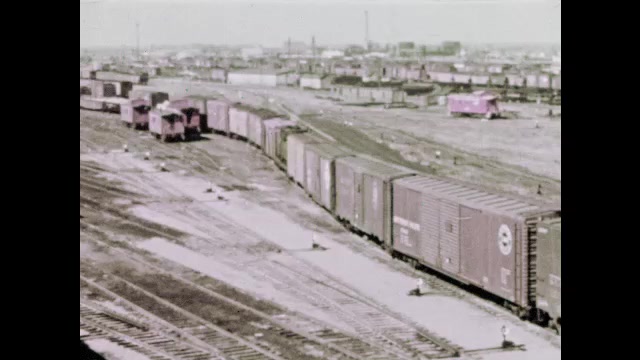 1950s: Train driving though rail yard. Map of Midwestern states, rail ...
