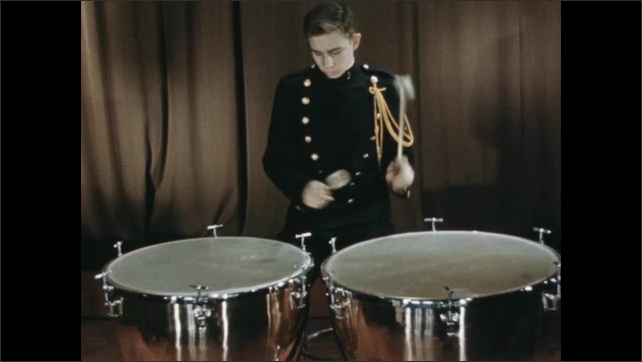 1950s: Man holding clapperboard, clapping. Man playing kettledrums. Man ...