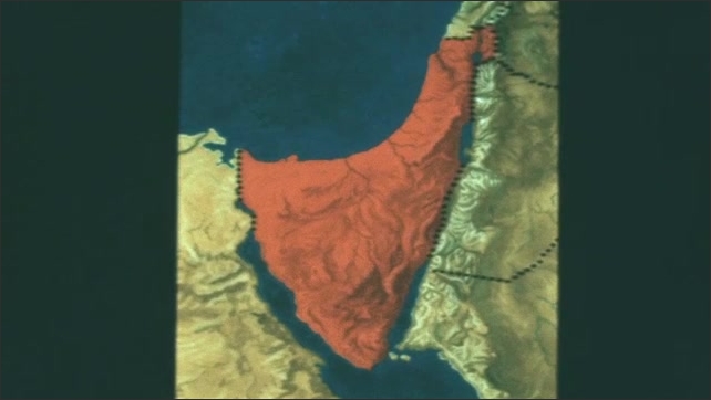 1970s: lady crosses city street. Lady in yellow-orange blazer. Map of ...