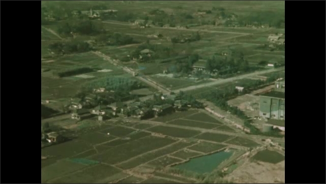 1950s: Aerial view of rural green landscape. Terraced gardens ...