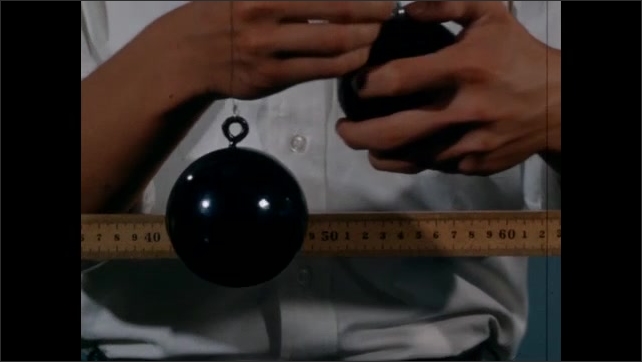 1960s: Student conducts physics experiment. Student detaches weight ...