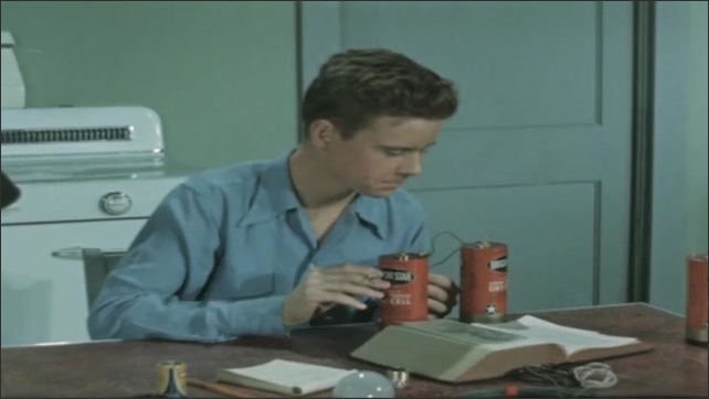 1940s: boy experiments with dry cells and wire. Boy smiles. Boy reads ...