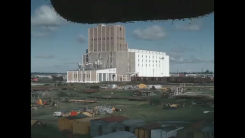 1960s: Huge grain elevator complex. Bungalow on a farm. – Archival Footage