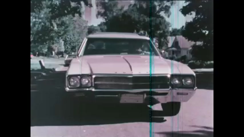 1970s: Car stops quickly in road, man exits and leads a boy out of the ...