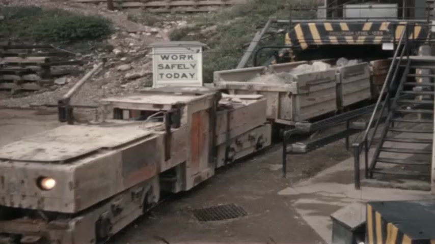 1960s: Freight train carrying rocks goes through tunnel. Clapperboard ...