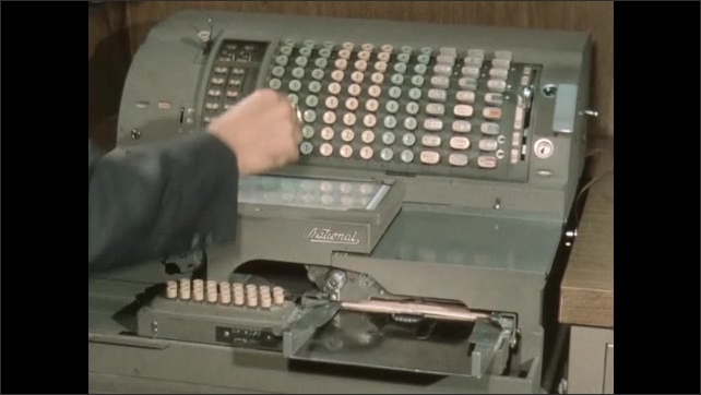 1950s: Hands operating banking machine. – Archival Footage