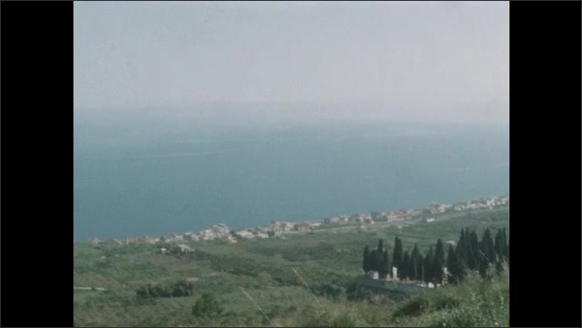 1950s: Pan across field, bay. – Archival Footage