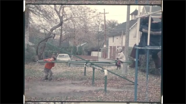 1970s: Kids in playground. Close up of boy, zoom out, kids playing in ...