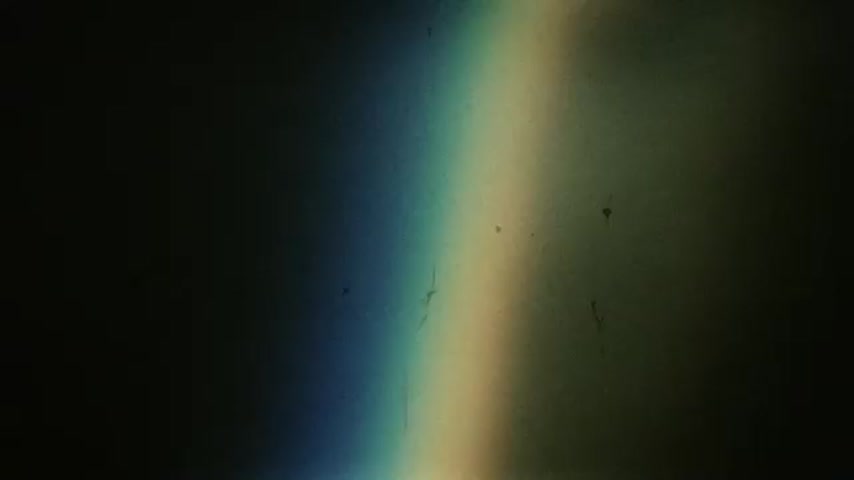 1960s: Rainbow colored ray of light. Rainbow over countryside ...