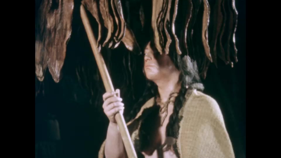 1960s: Museum display of woman smoking fish on racks. – Archival Footage