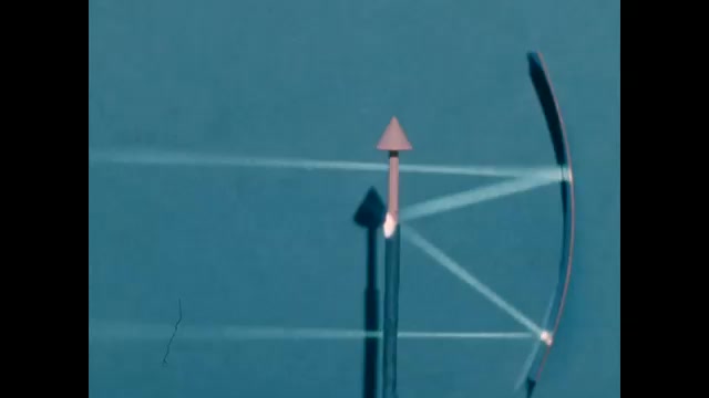 1950s: Metal cone, pipe and curved piece of metal. Light rays shining ...