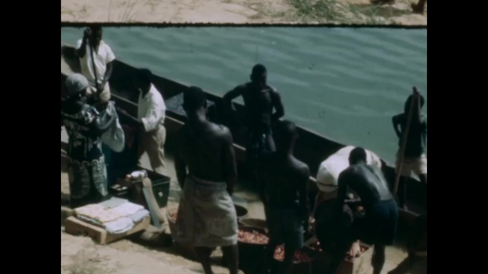 1960s: People trade baskets of food for machetes. – Archival Footage