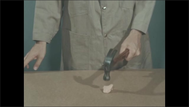 1960s: Hands holding putty ball, pinching, stretching putty. Hands ...