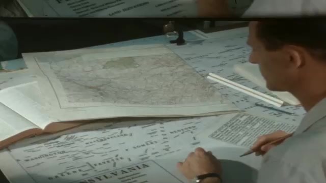 1950s: Man creating a large map of Pennsylvania. – Archival Footage